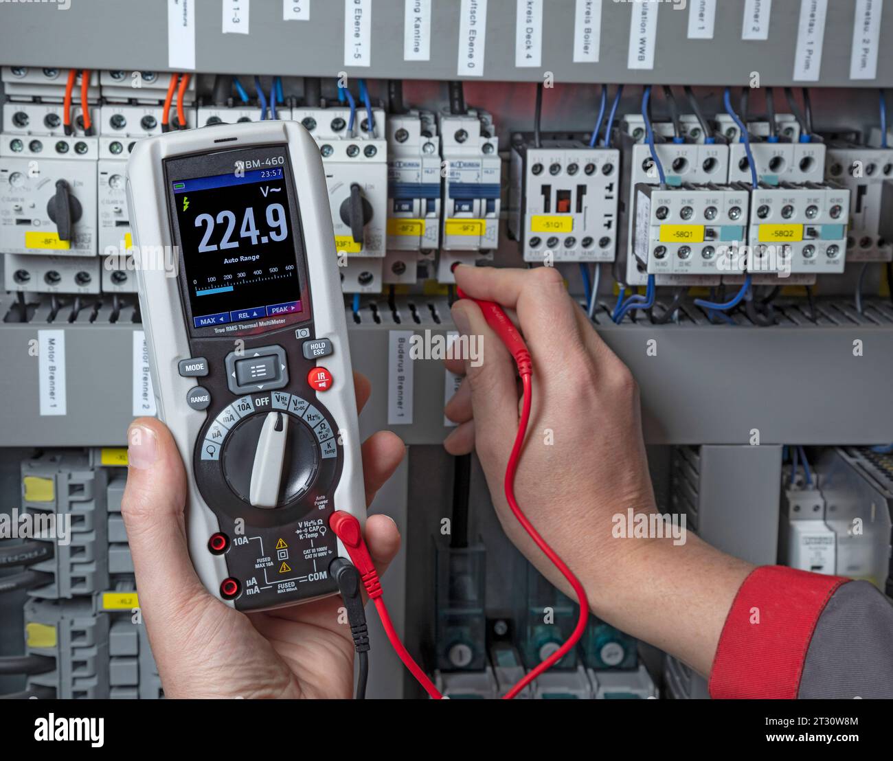 electrician measuring with multimeter inside a switch cabinet Stock ...