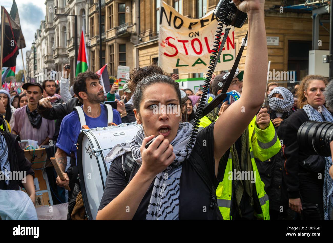 London / UK - Oct 21 2023: A muslim woman uses a megaphone next to a ...