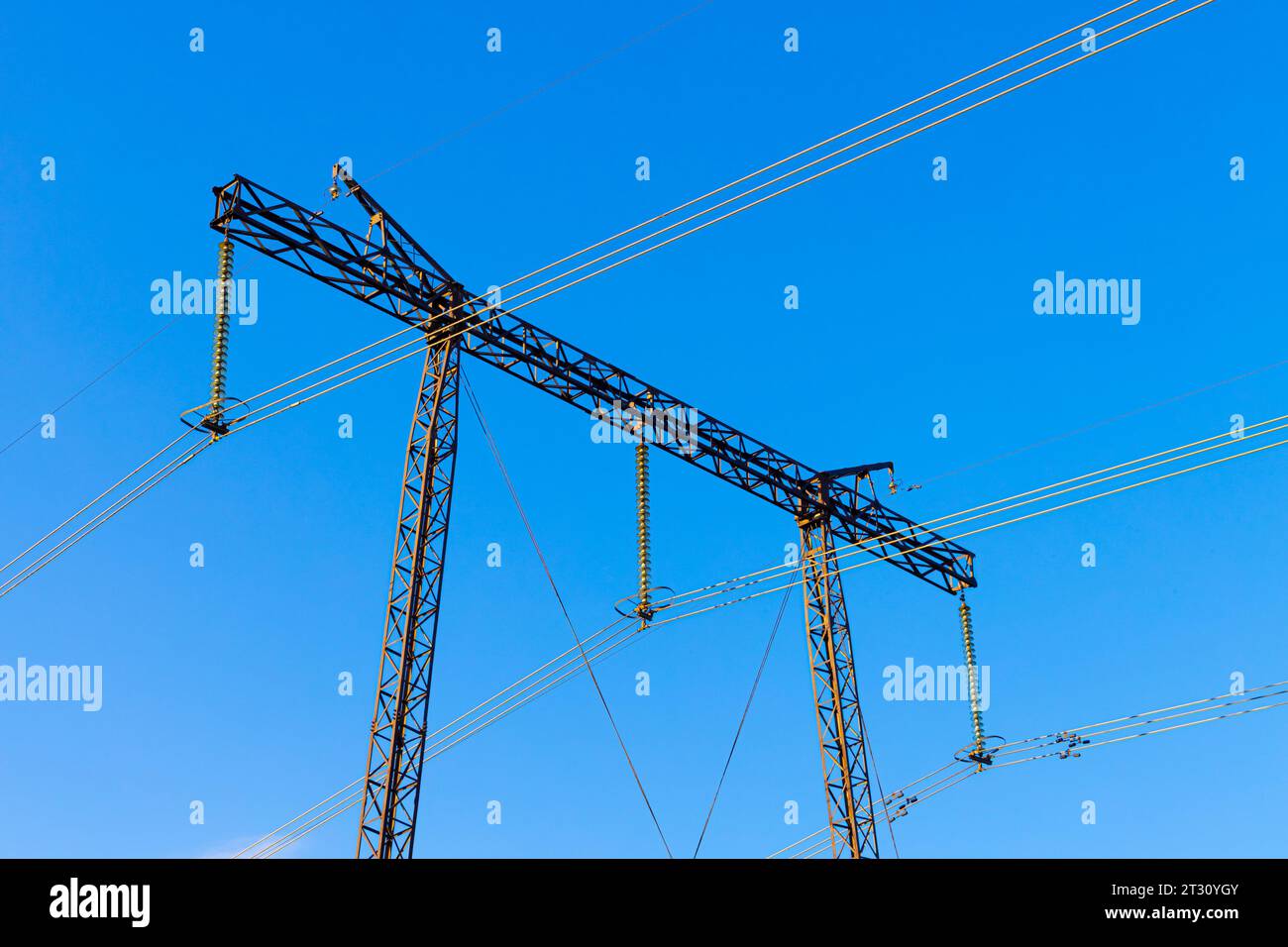 power line support with wires against a blue sky. electricity line ...