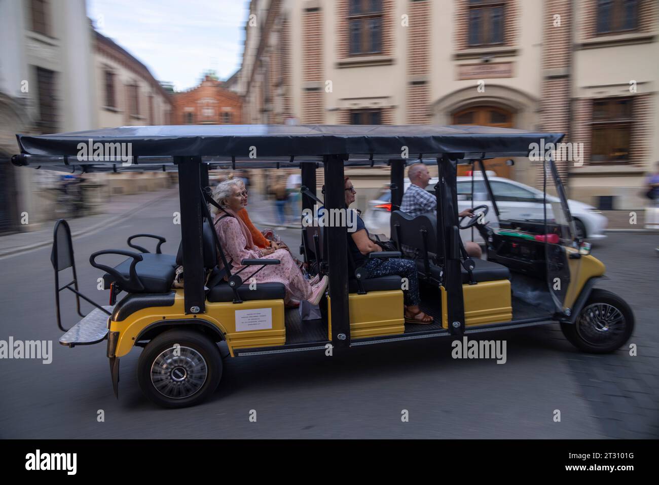 tourists in electric cart on tour, old town, Krakow, Poland Stock Photo ...