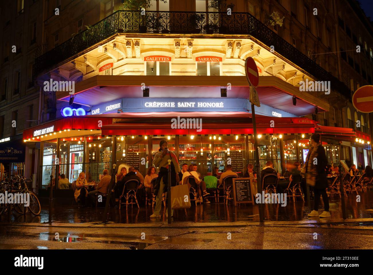 A night shot of the outside of creperie Saint Honore , French street ...
