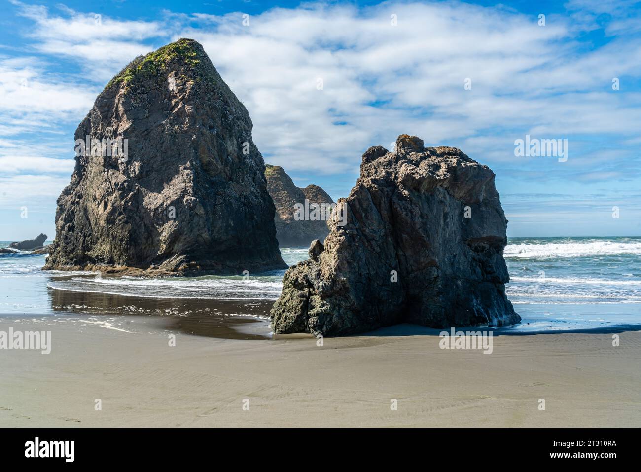 A view of Meyers Creek Beach with waves and rock formations on the ...