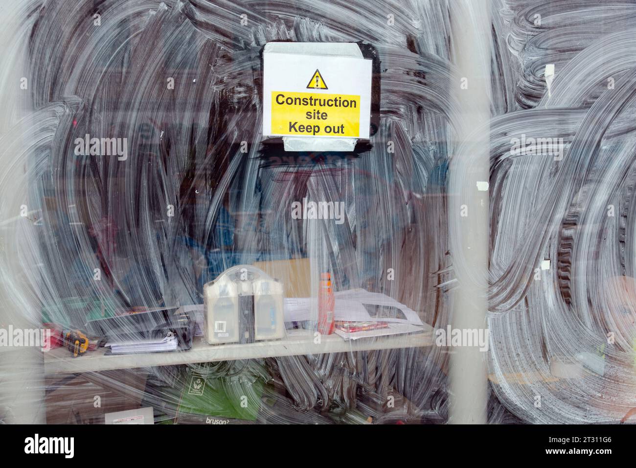 Construction Site Keep Out sign on the window of a shop during ...