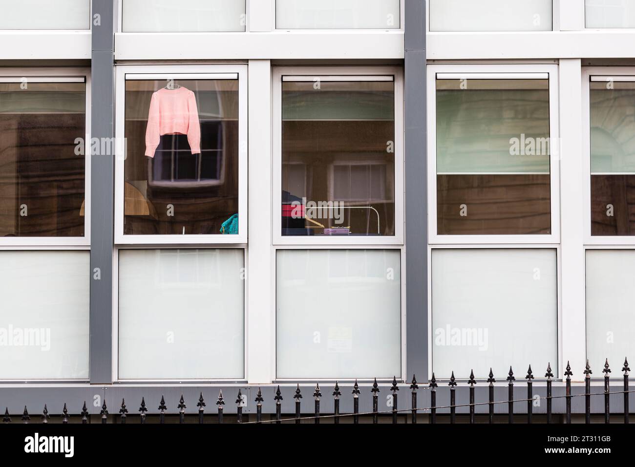 A winter sweater hanging up to dry on the inside of a window Stock ...