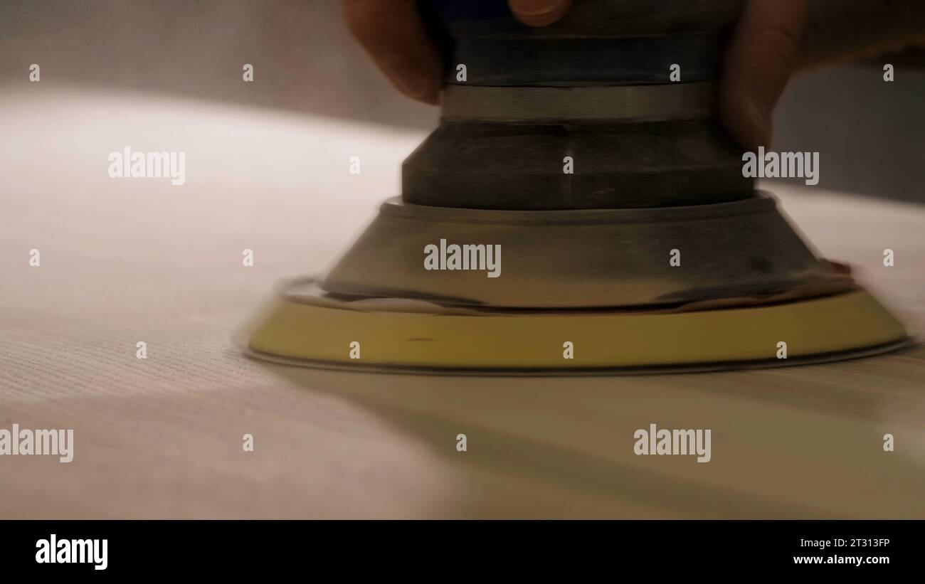 Craftsman hands polishing wooden table with machine. Creative. Man ...