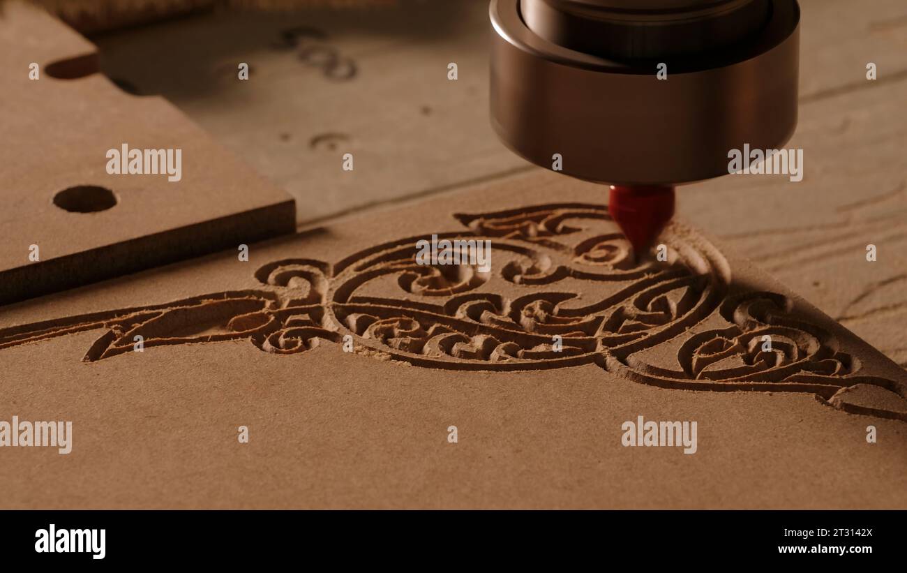 Carving geometric pattern on wooden sheet with small drill at woodwork ...