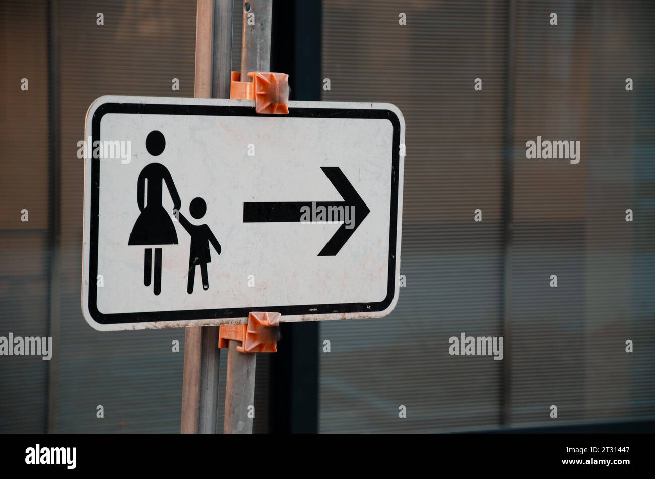 Additional road sign indicating the way for pedestrians. The background ...