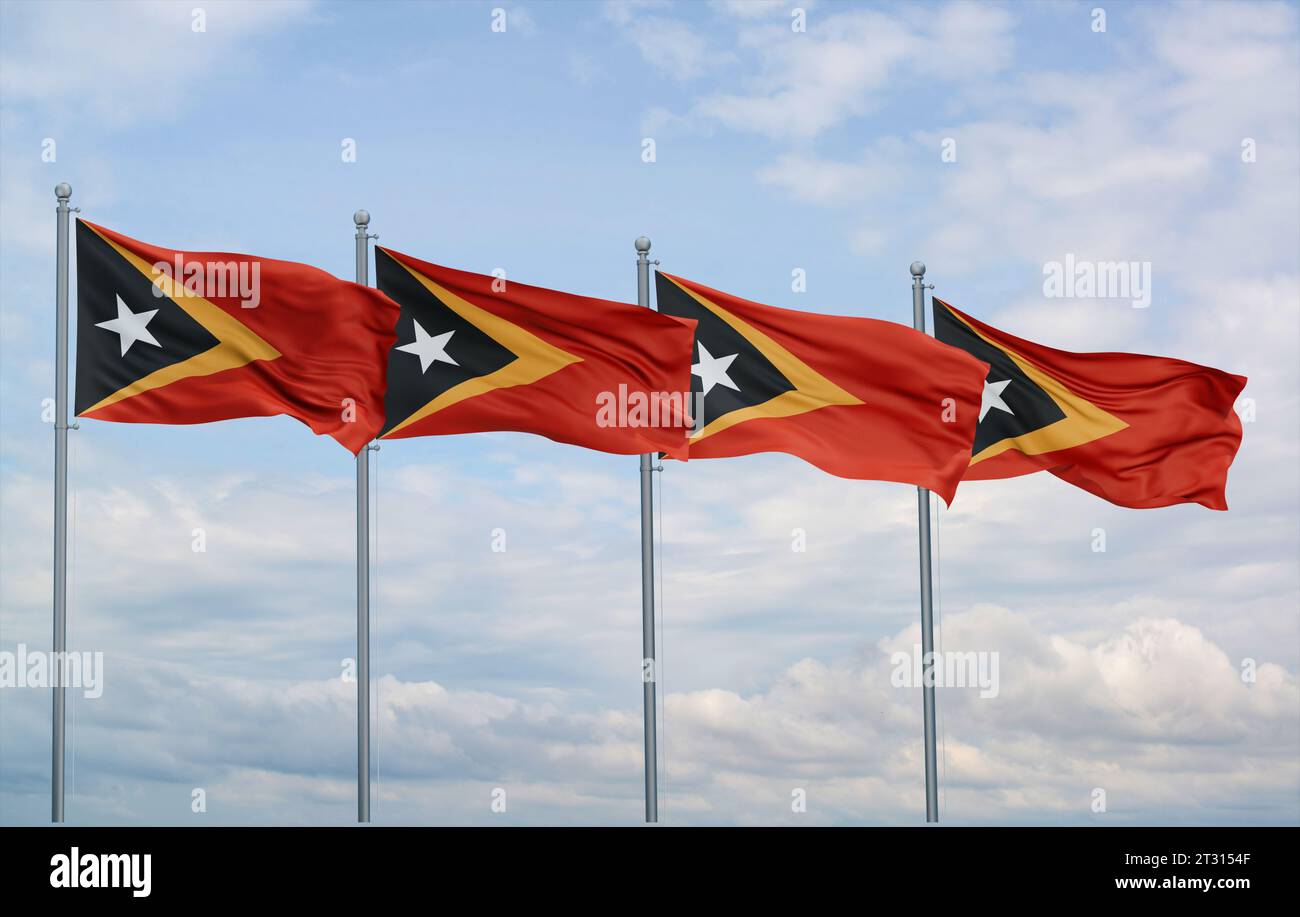East Timor four flags in row waving together on blue cloudy sky ...