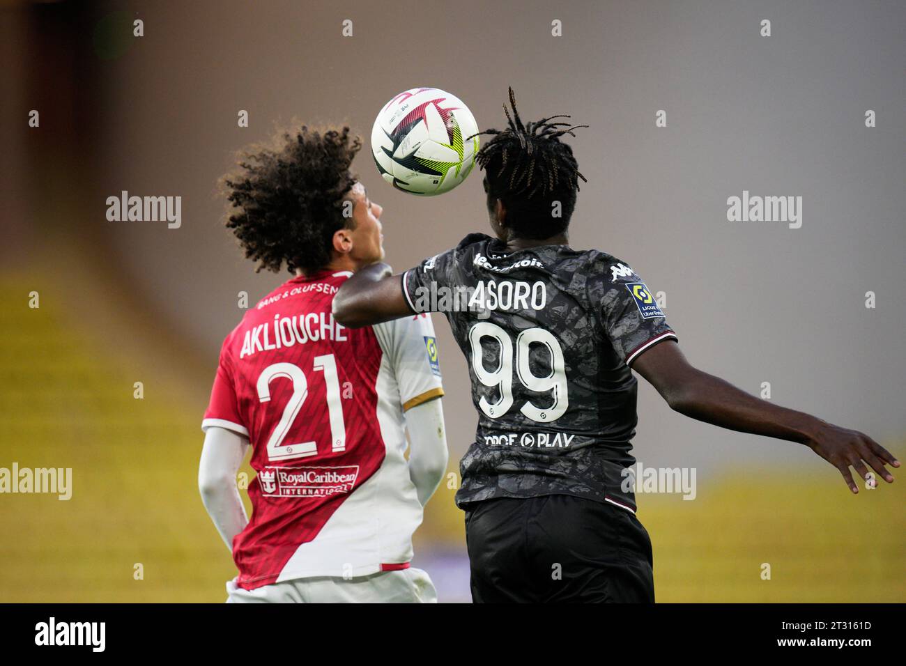 Monaco's Maghnes Akliouche jumps for the ball with Metz's Joel Asoro ...