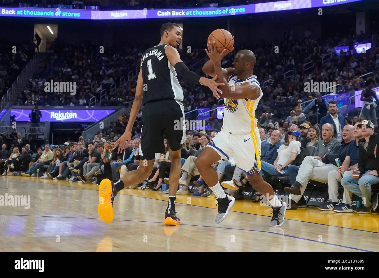 Golden State Warriors guard Chris Paul, right, is defended by San Antonio Spurs center Victor ...
