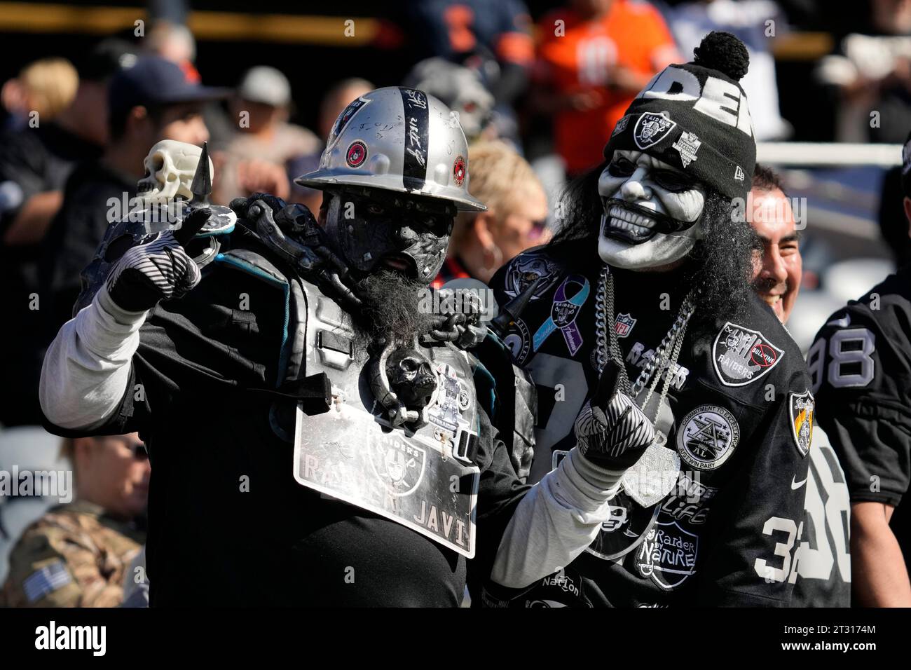 Las Vegas Raiders fans watch as players warm up before an NFL football ...