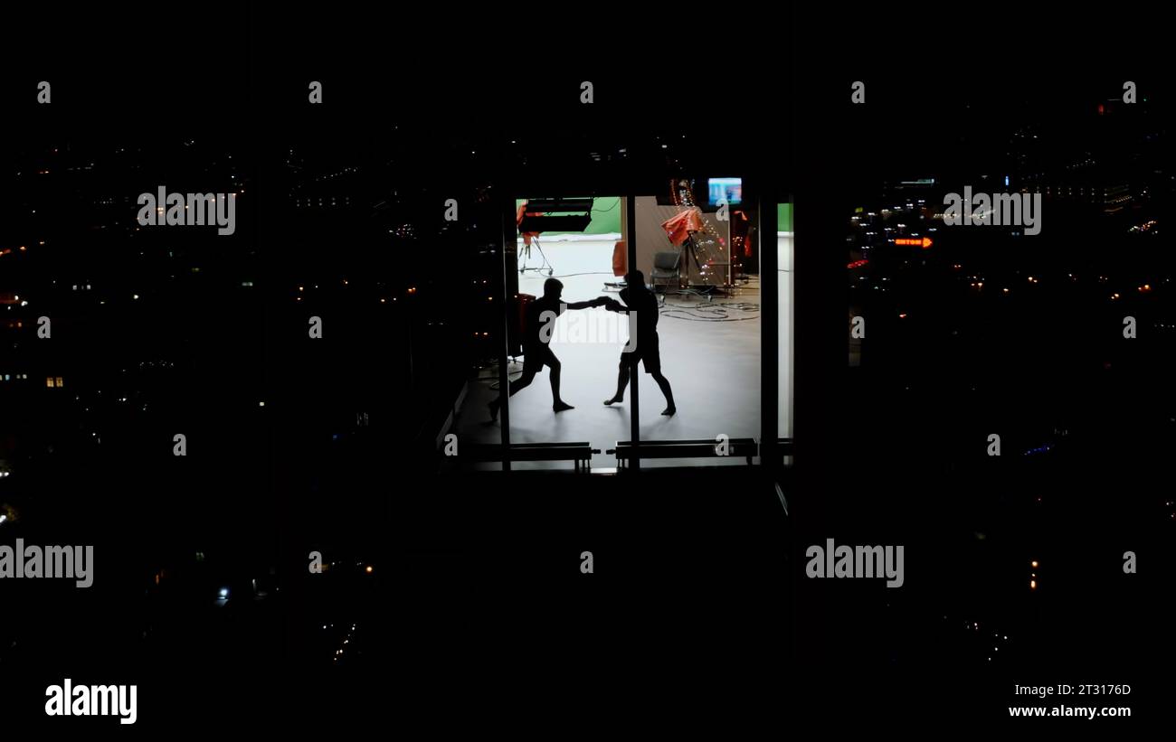 Aerial view of a skyscraper with sportsmen boxing inside. Stock footage ...