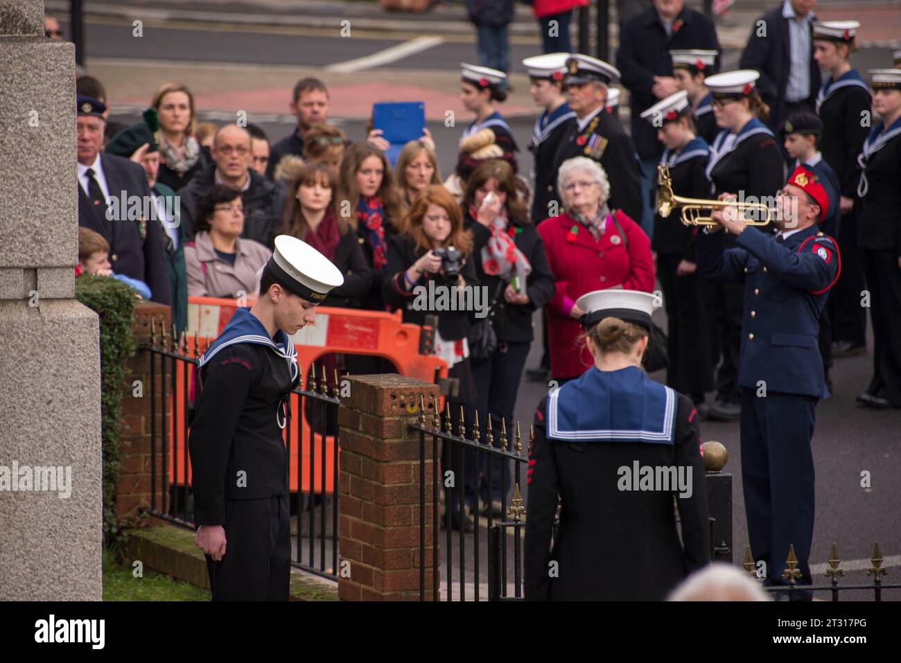 Navy cadets bow their heads while the last post is played at a local ...