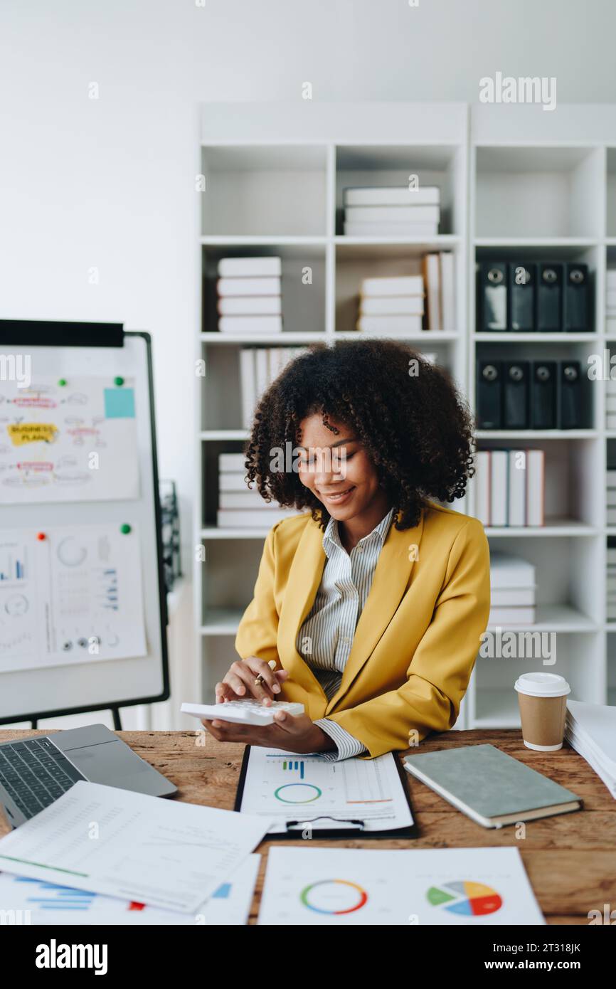 Young Asian Female Work With Financial Papers At Home Count On