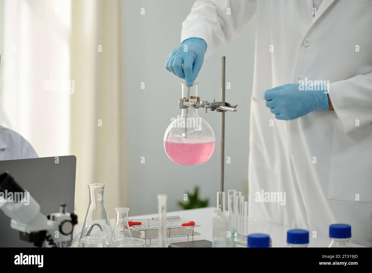 Researcher mixing reagent with activation powder to get chemical ...