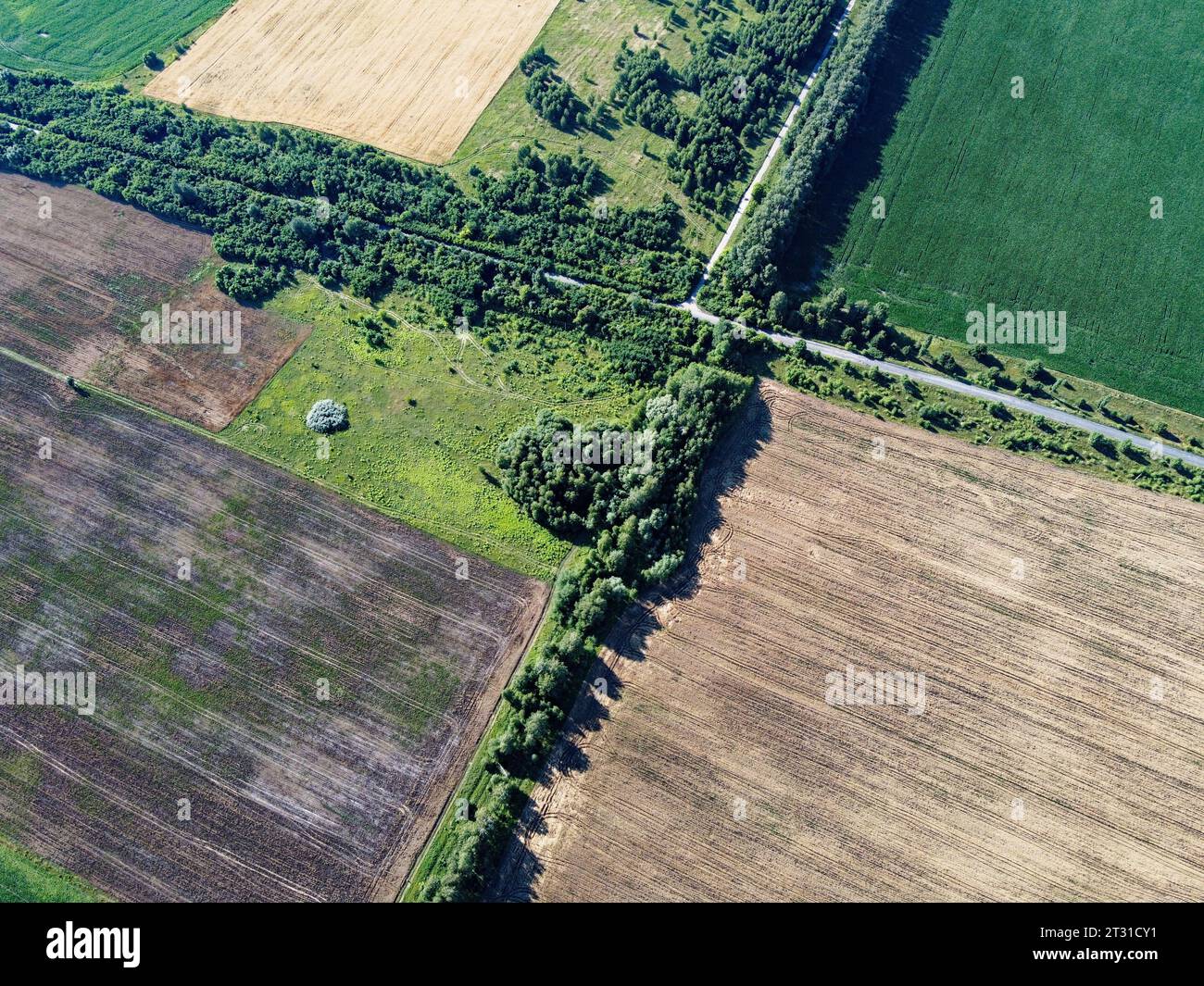 Crossroads of two roads among farm fields, aerial view. Agrarian ...