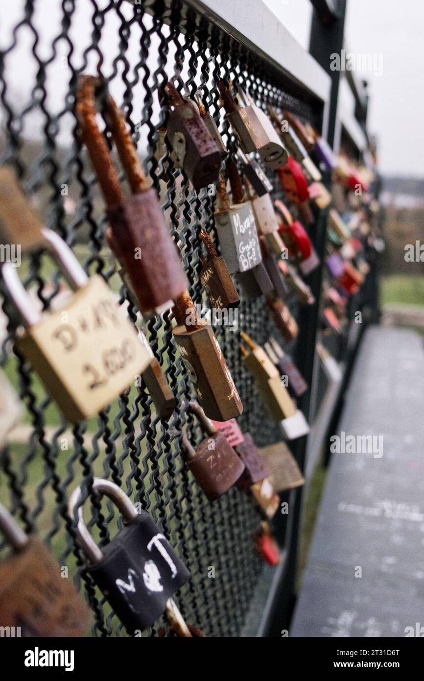 Lots of padlocks on the railing of the footbridge. Padlocks symbolizing ...
