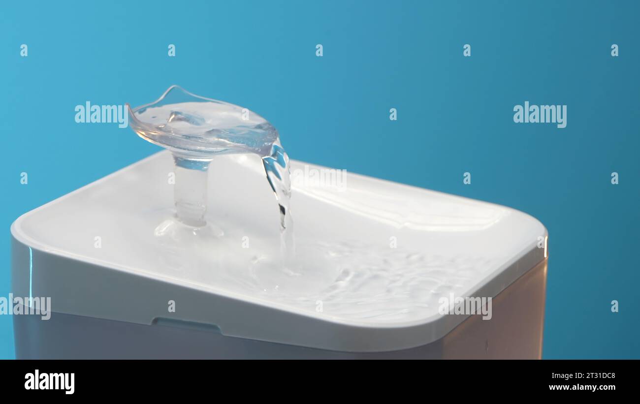 A small fountain with water. Action. Blue background with small ...