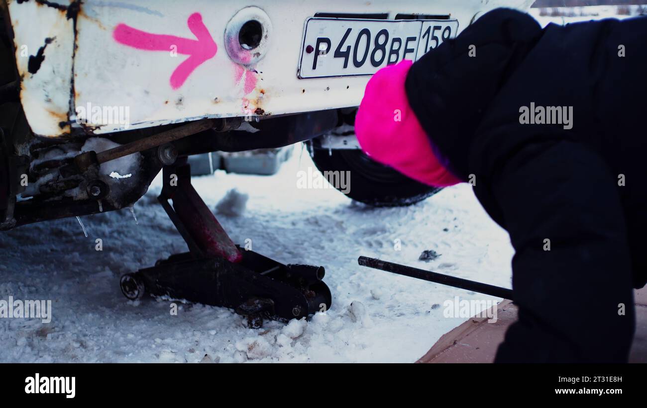 Repair of a Russian car. Clip. Men in the winter cold make a white car ...