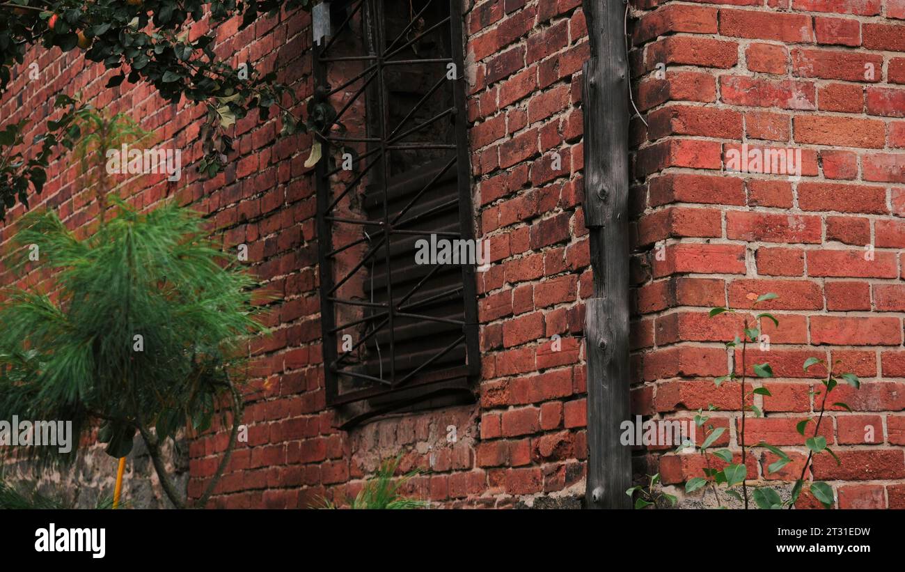 Close-up of brick abandoned building. Stock footage. Facade of abandoned old red brick house ...