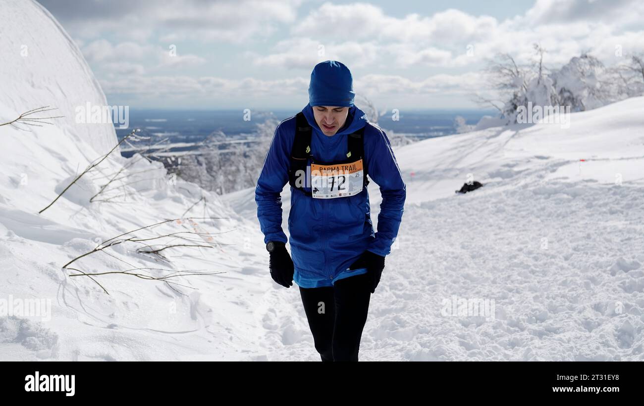 Winter sports. Clip. Men in sports uniforms with numbers who run through the snow at ...