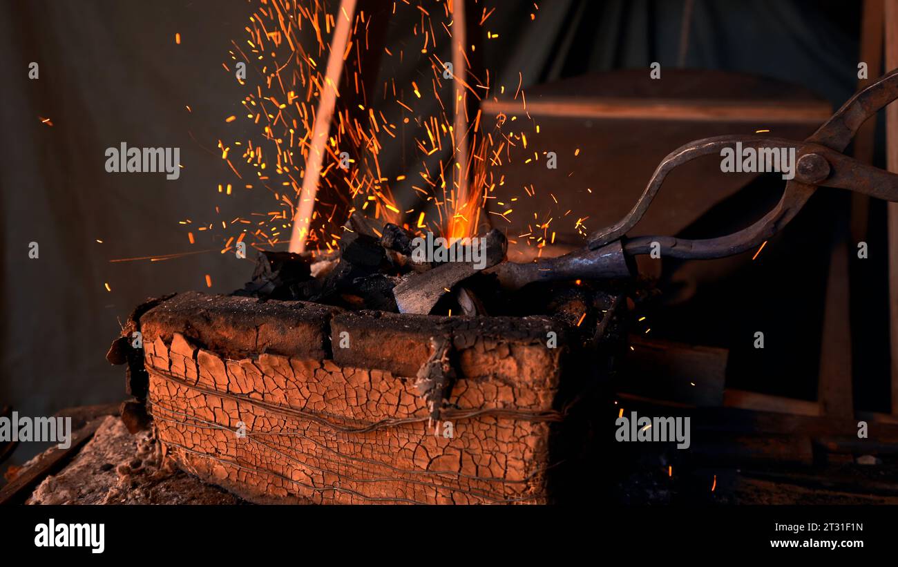 Working with split iron. Media. A man is a blacksmith who forges iron ...