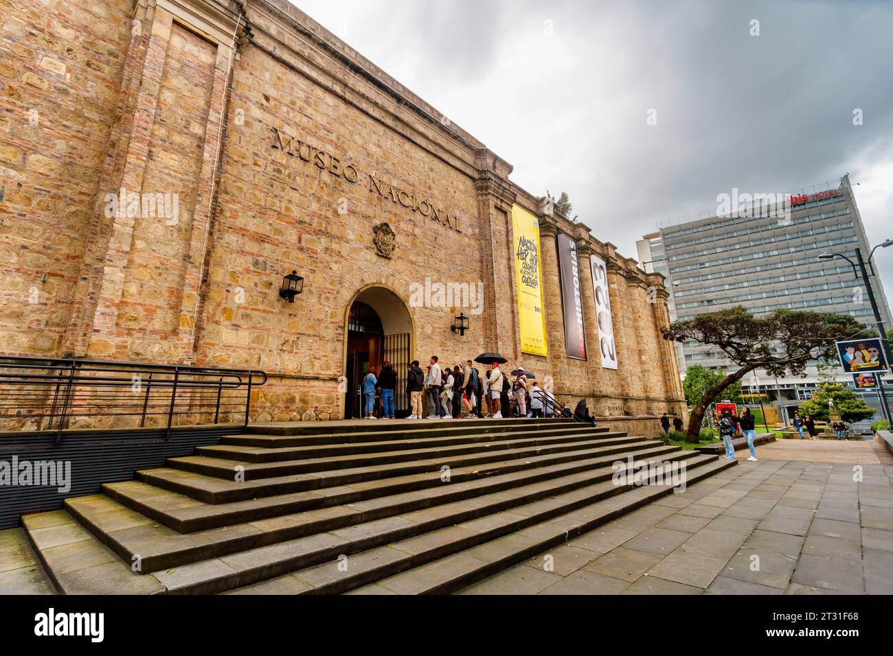 Bogota, Colombia - January 8, 2023: People line up in the rain to enter ...