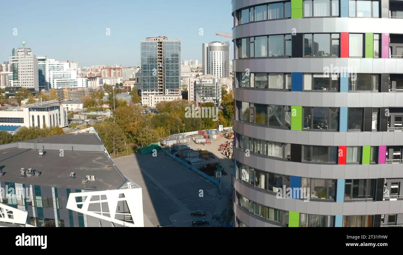 Modern high-rise building on background of stadium construction. Stock ...