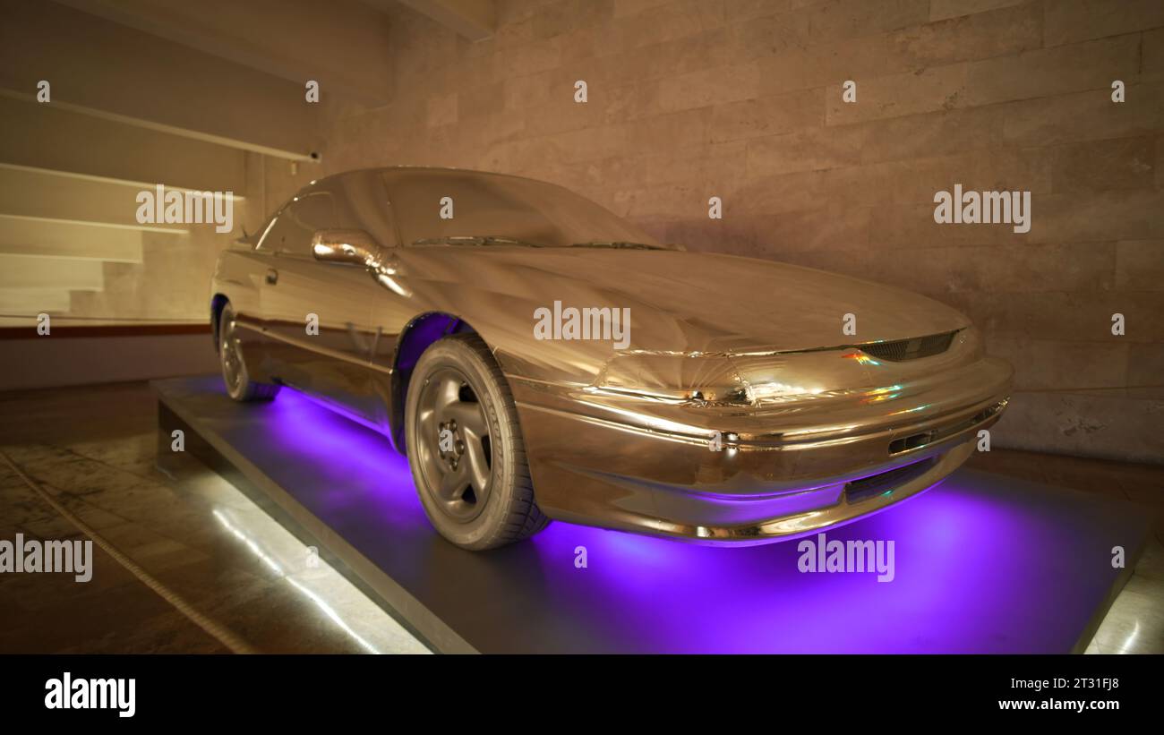 Illuminated car in showroom. Action. Cool car with gilding and backlit ...