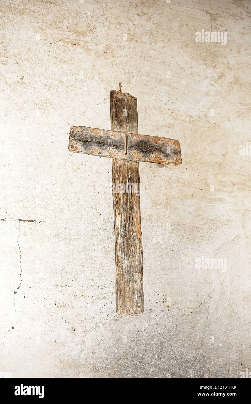 A wooden cross in front of a white wall in a religious setting Stock ...