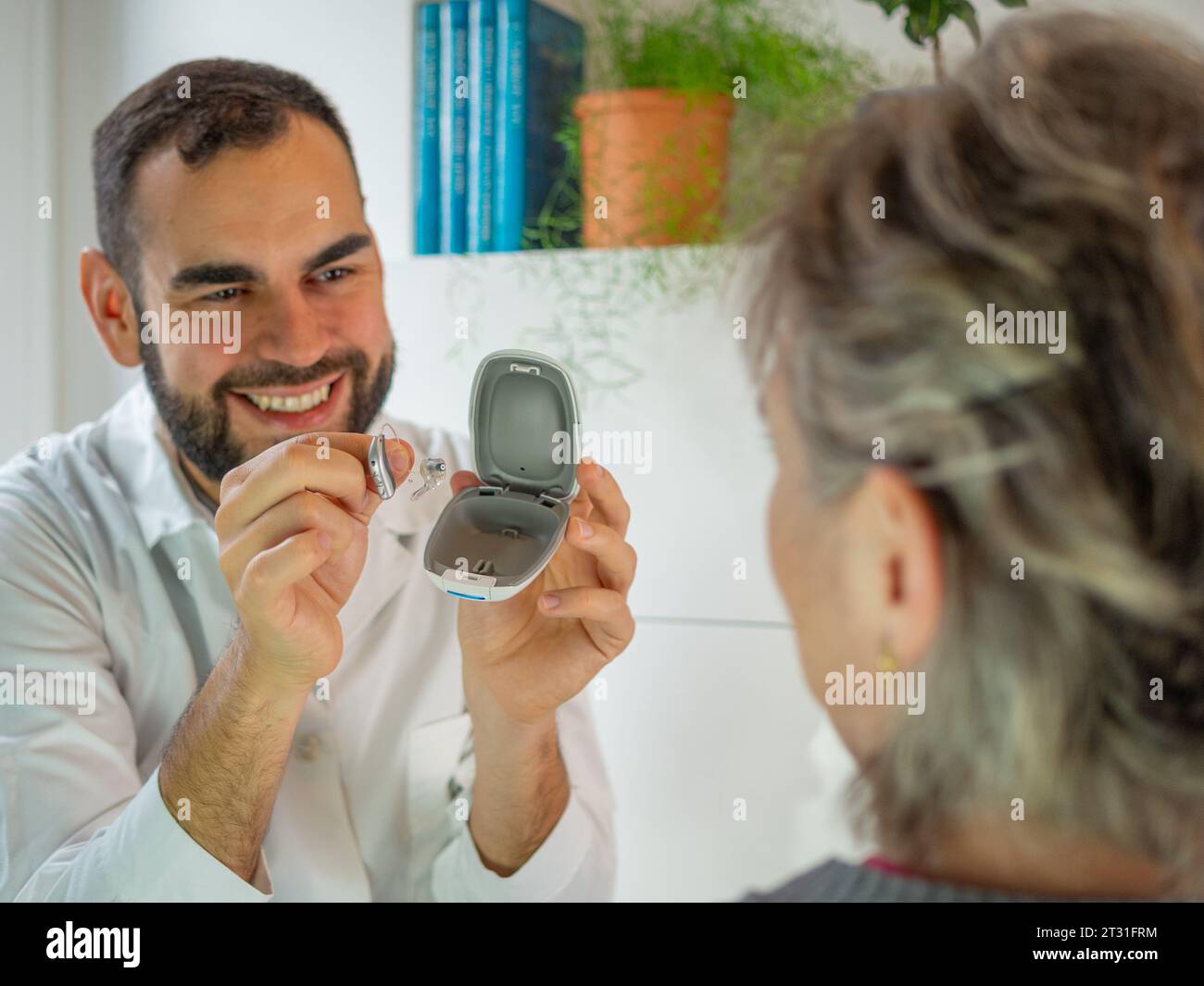 Doctor showing hearing aid hi-res stock photography and images - Alamy