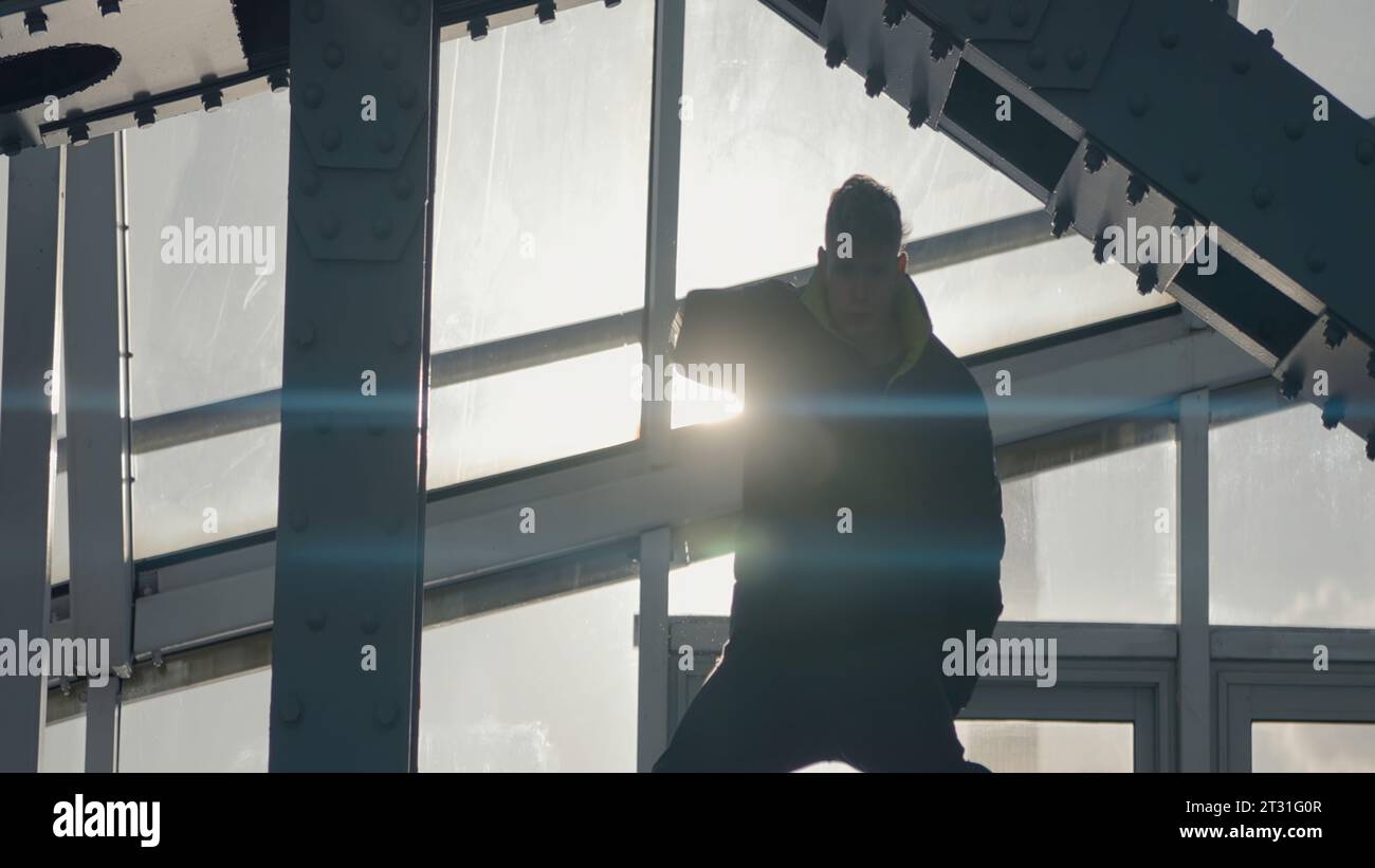 Guy dancing hip hop on bridge. Action. Cool dance in modern style of ...