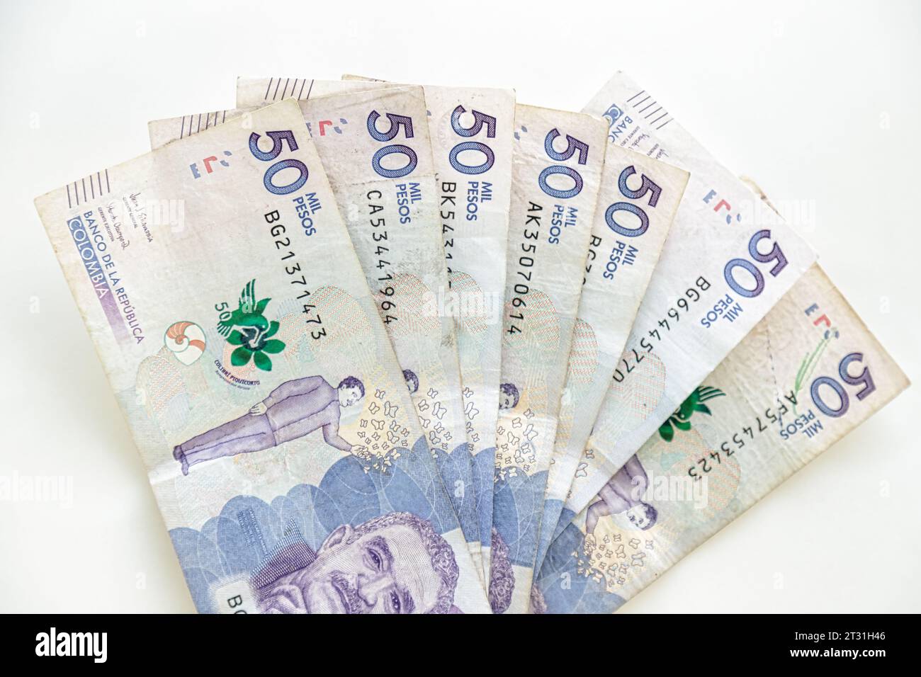Banknotes of 50 thousand Colombian pesos in fan shape on a white ...