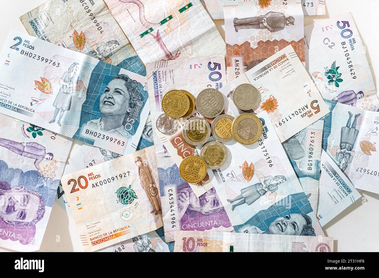 Colombian pesos coins on bills of different denominations Stock Photo ...