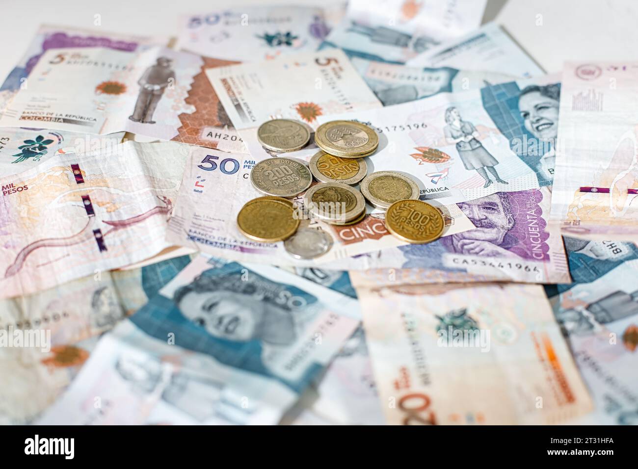 Macro closeup of Colombian peso coins on banknotes of different ...