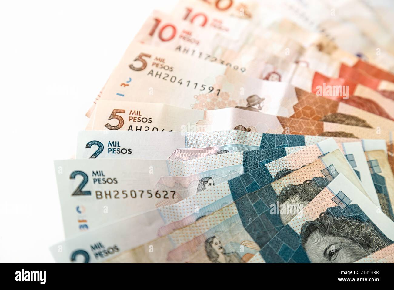 Macro closeup of Colombian pesos of different value in the shape of a ...