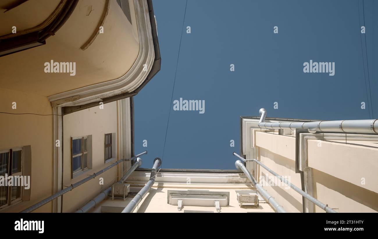 Bottom view of sky and facade of old house. Action. Beautiful view of ...