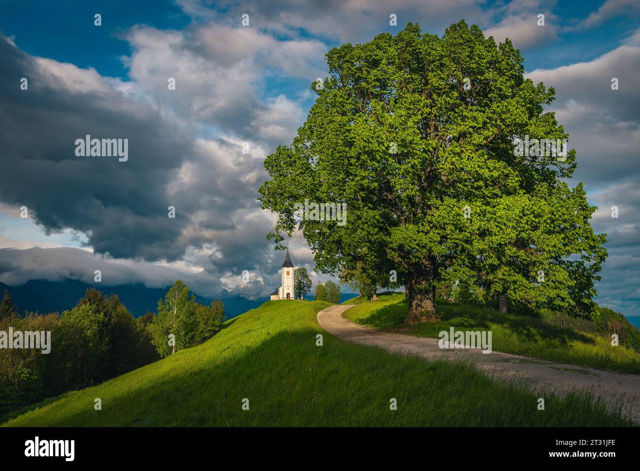 Countryside spring landscape and church on the mountain ridge. Cloudy ...