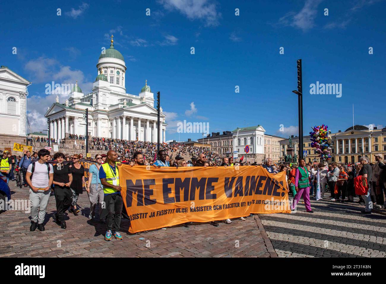 Demonstrators holding a large banner at Me emme vaikene! anti-racism ...