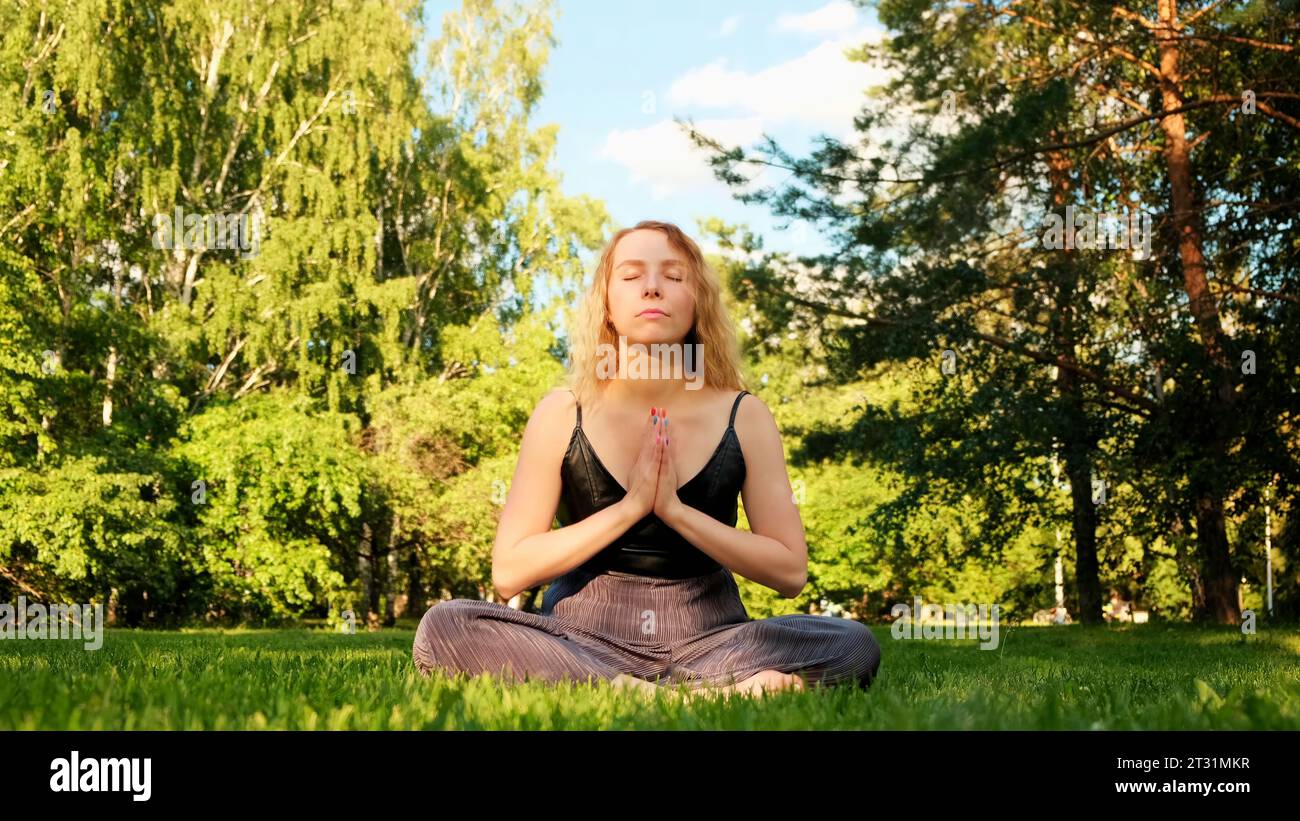 Meditation in the lotus position. Concept. A beautiful woman sitting in ...
