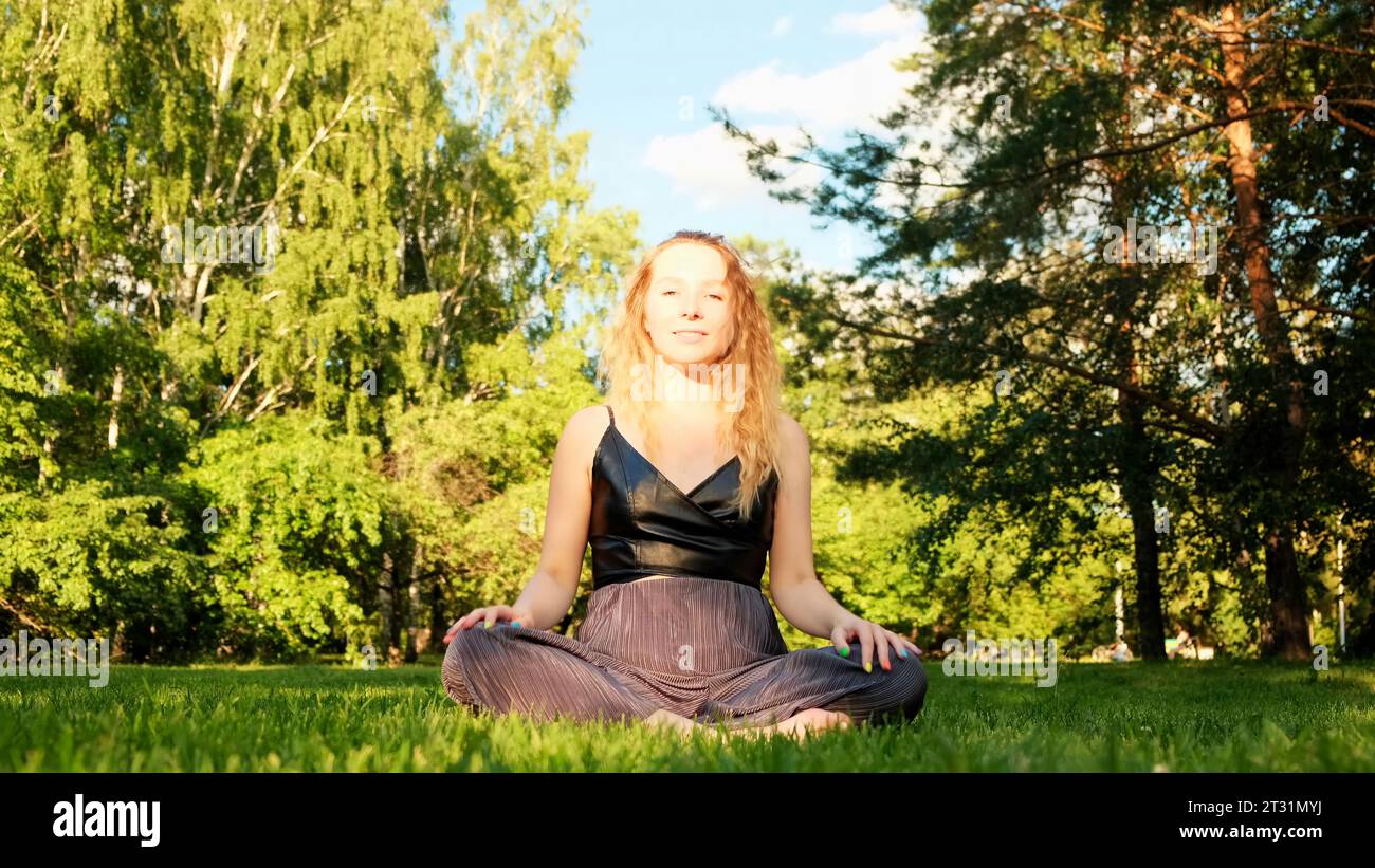 Meditation in the lotus position. Concept. A beautiful woman sitting in ...