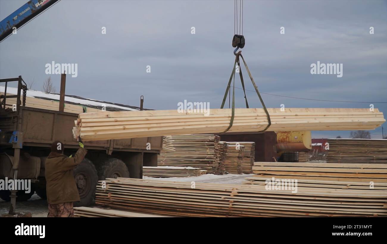 Wooden planks are lifted by crane for transportation. Clip. Loading of ...
