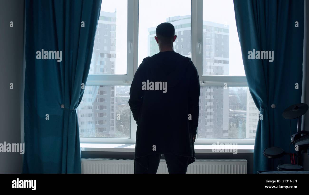 Man standing at a window in a hotel room hi-res stock photography and ...