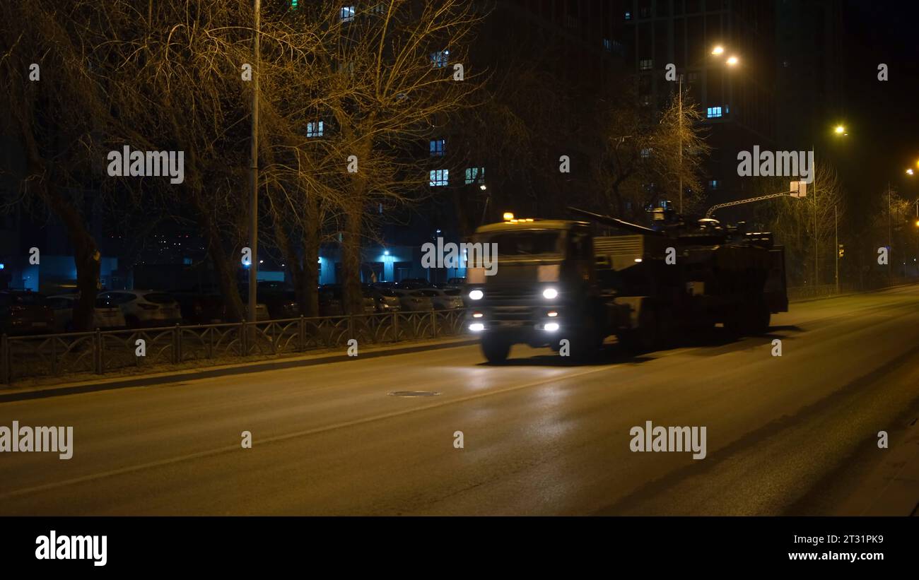 Night road with military tank riding on truck. Concept. Night ...
