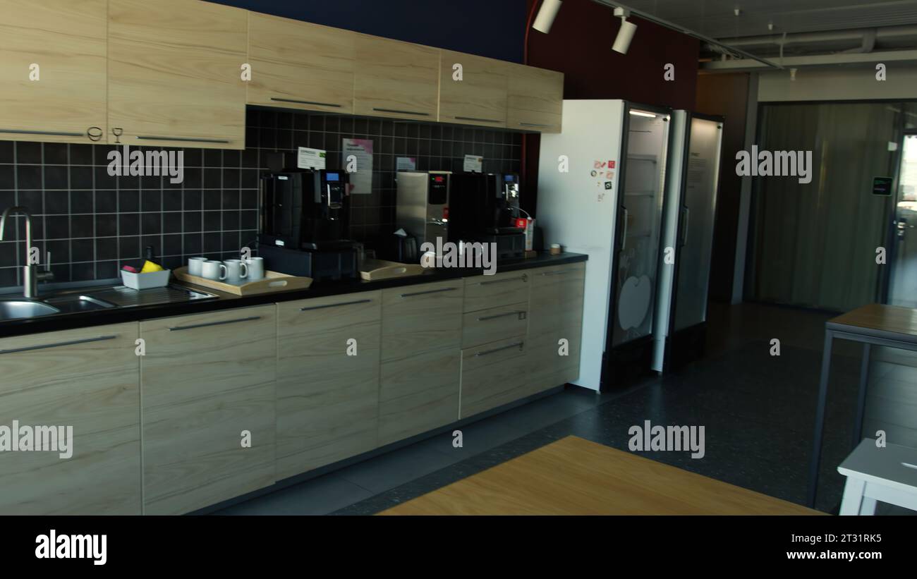 An empty kitchen. Action. Space for cooking and tables with stools in ...