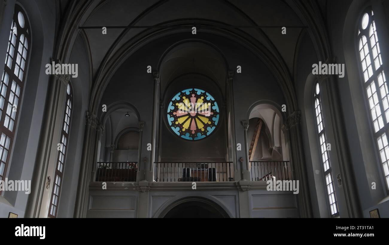 Stained glass round window inside church. Action. Beautiful interior of ...