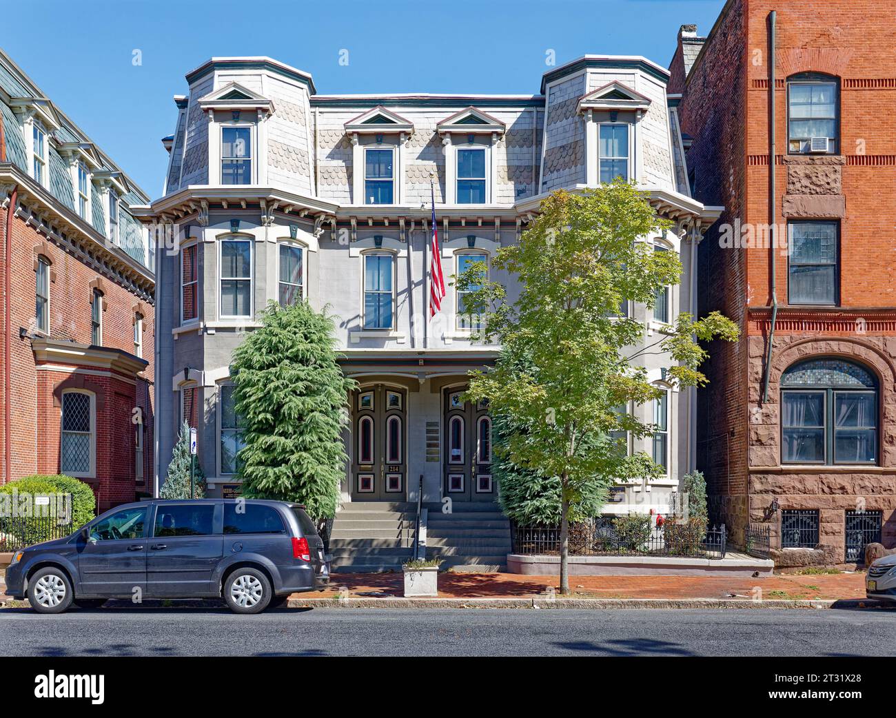 Downtown Trenton: Mirror twin townhouses of grey painted stone, with ...