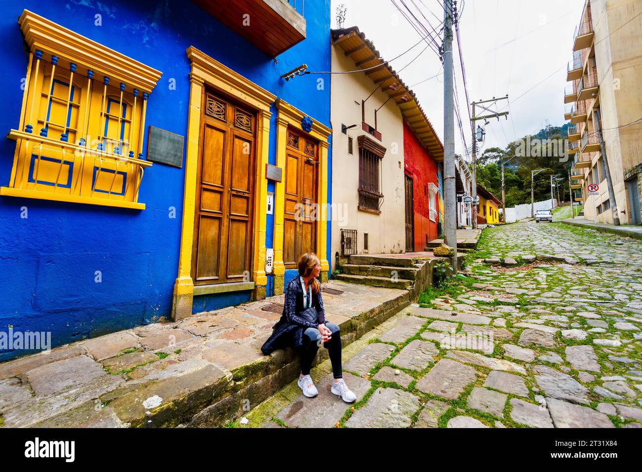 Tourist woman sitting on a street in La Candelaria, Bogota, Colombia ...