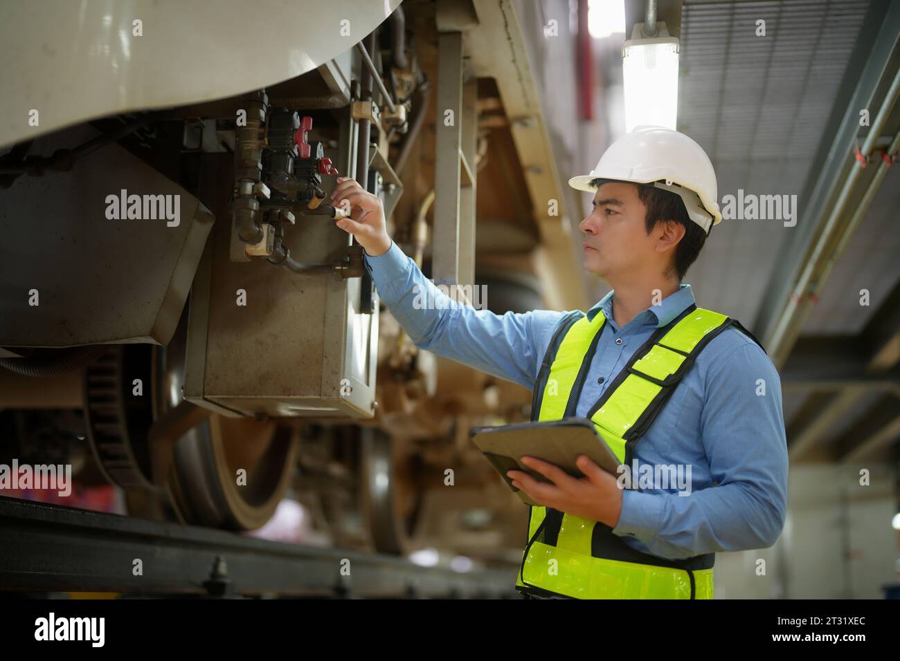 Engineer inspecting sky train in the maintenance plant Stock Photo - Alamy
