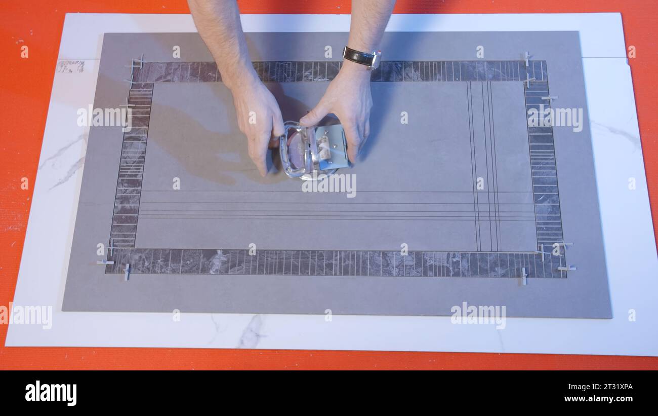Worker connects tile pattern. Creative. Man connects details of square ...